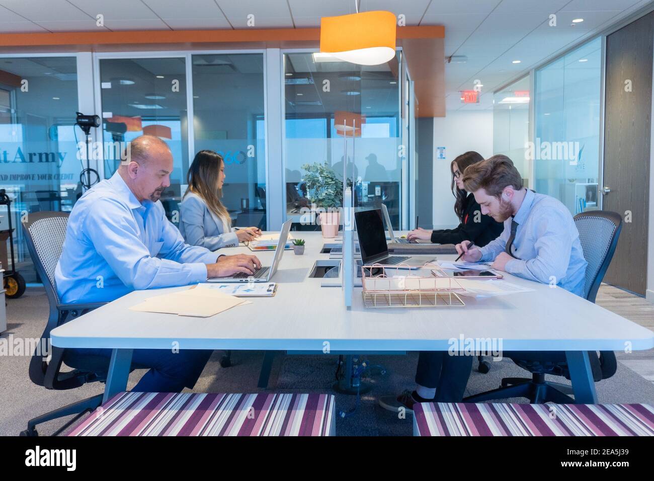 Office employee having a meeting with their team Stock Photo - Alamy