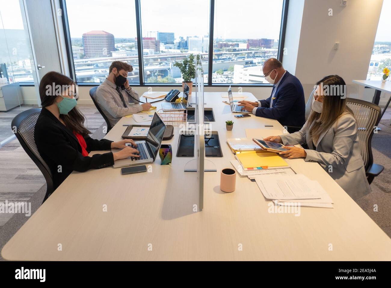 Office employee having a meeting with their team Stock Photo - Alamy