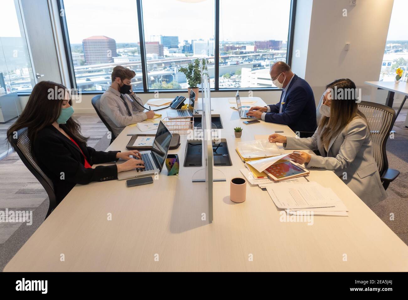 Office employee having a meeting with their team Stock Photo - Alamy