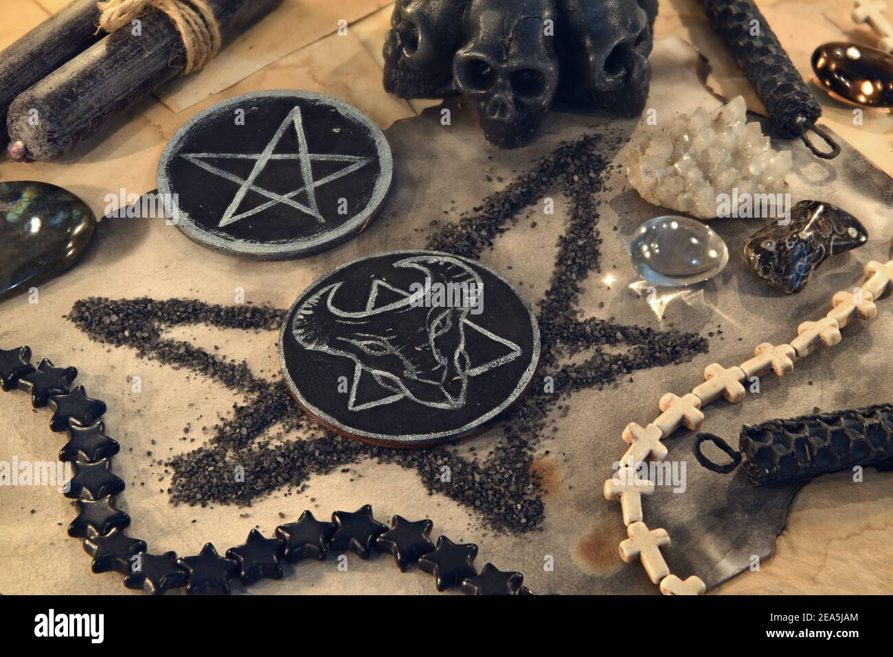 Scary symbols of devil and pentagram with black candles and crystals on ...