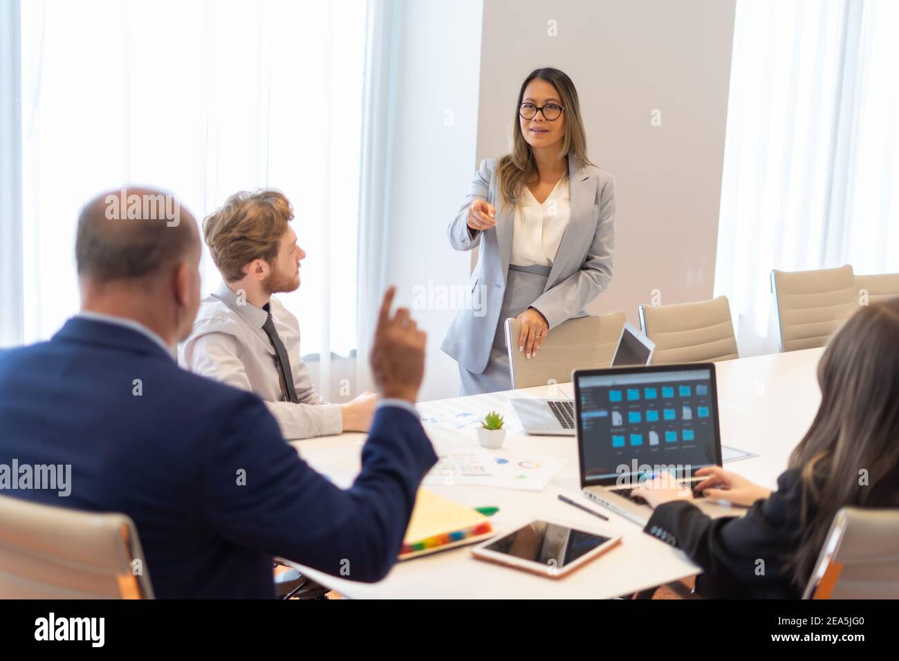 Office employee having a meeting with their team Stock Photo - Alamy