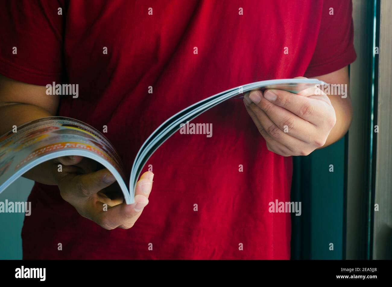 Man standing reading book image focus Stock Photo - Alamy