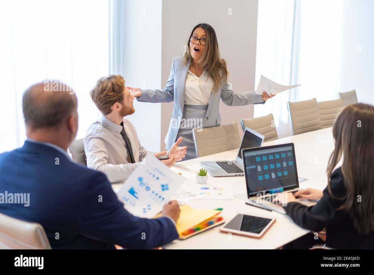 Office employee having a meeting with their team Stock Photo - Alamy