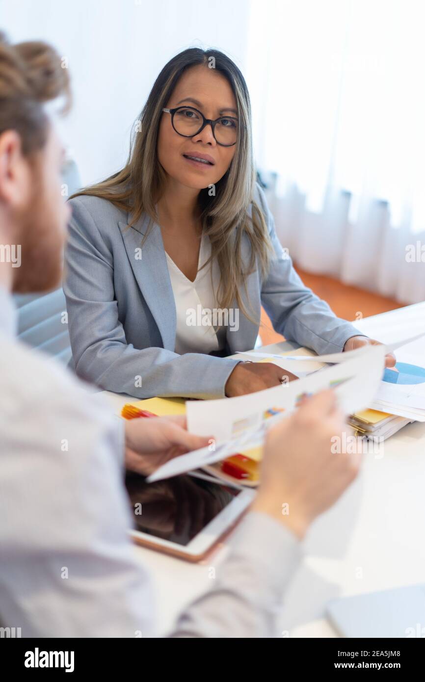 Office employee having a meeting with their team Stock Photo - Alamy