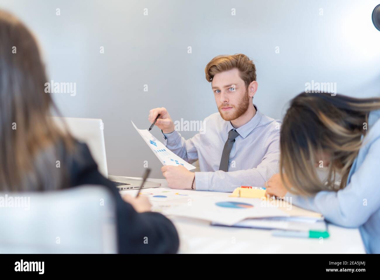 Office employee having a meeting with their team Stock Photo - Alamy