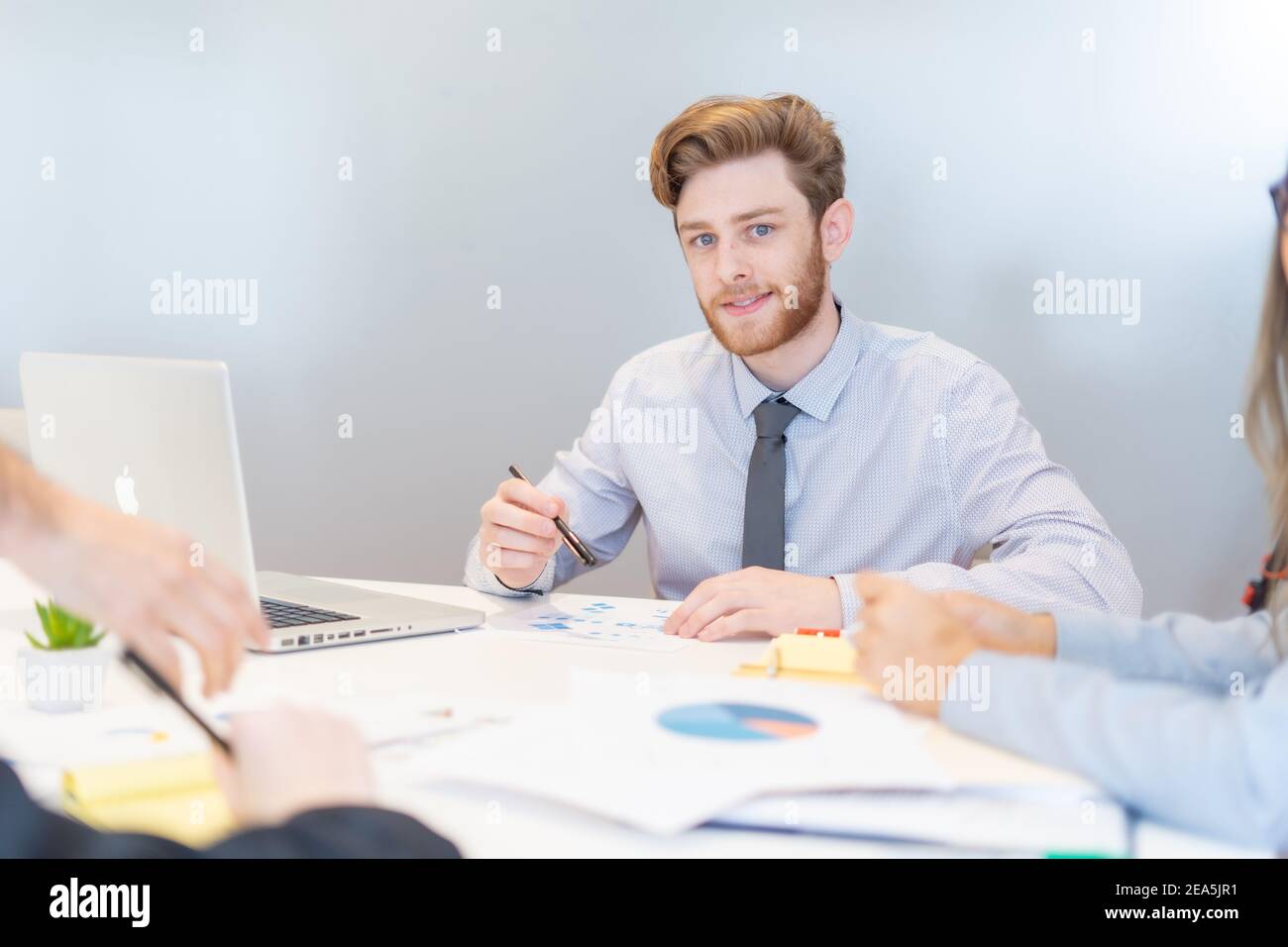 Office employee having a meeting with their team Stock Photo - Alamy