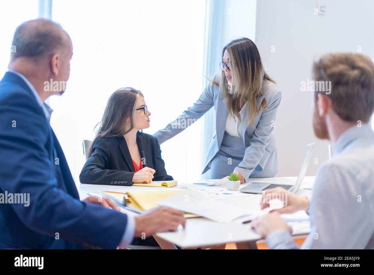 Office employee having a meeting with their team Stock Photo - Alamy