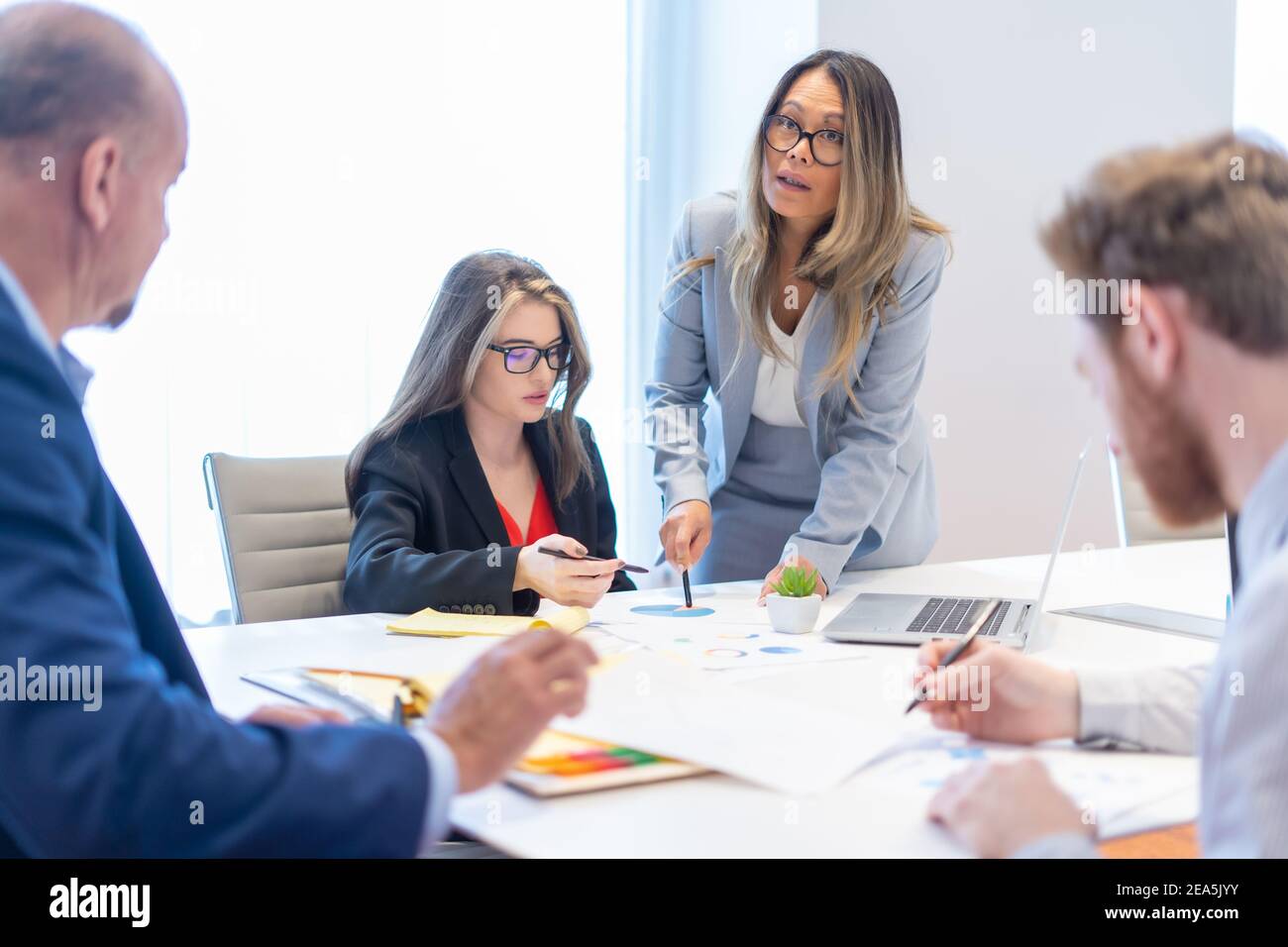Office employee having a meeting with their team Stock Photo - Alamy