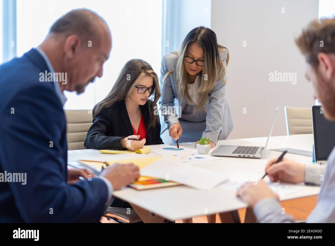 Office employee having a meeting with their team Stock Photo - Alamy