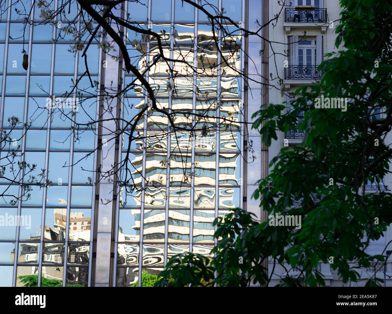 Building reflected in glass window of modern building Stock Photo - Alamy
