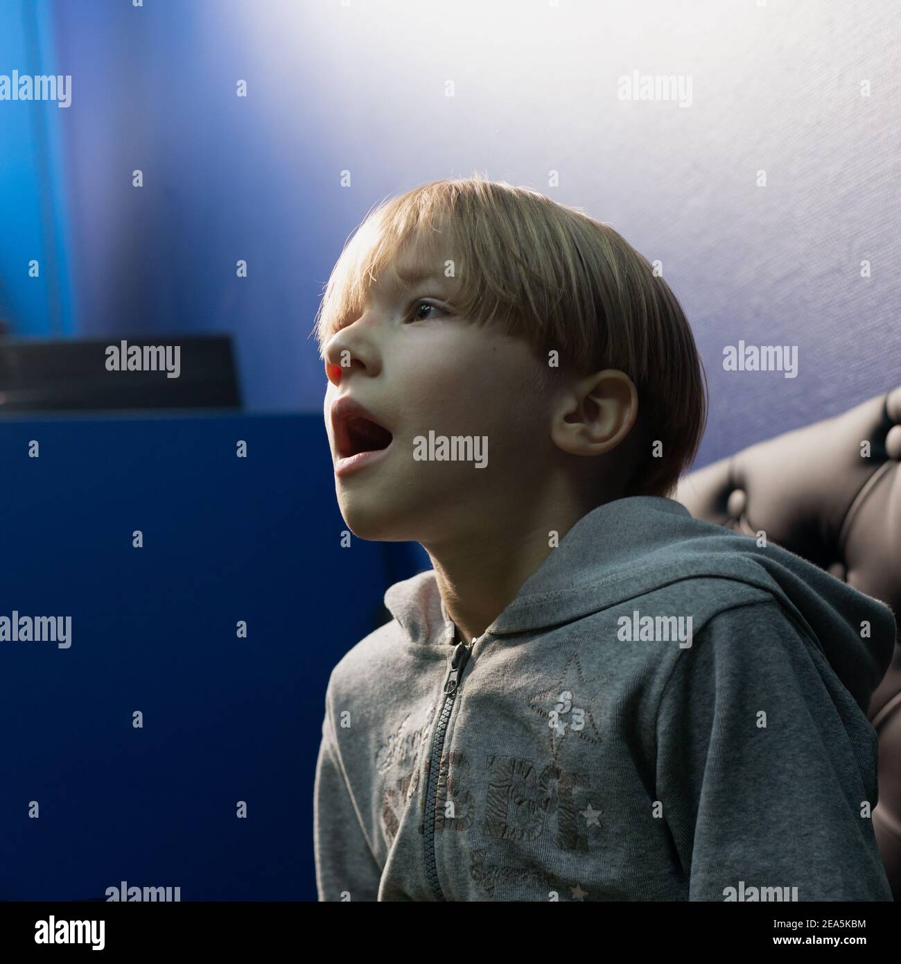 portrait of little impressed boy with open mouth locking up Stock Photo ...