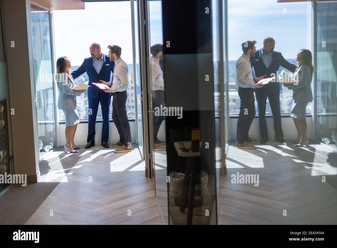 Office employee having a meeting with their team Stock Photo - Alamy