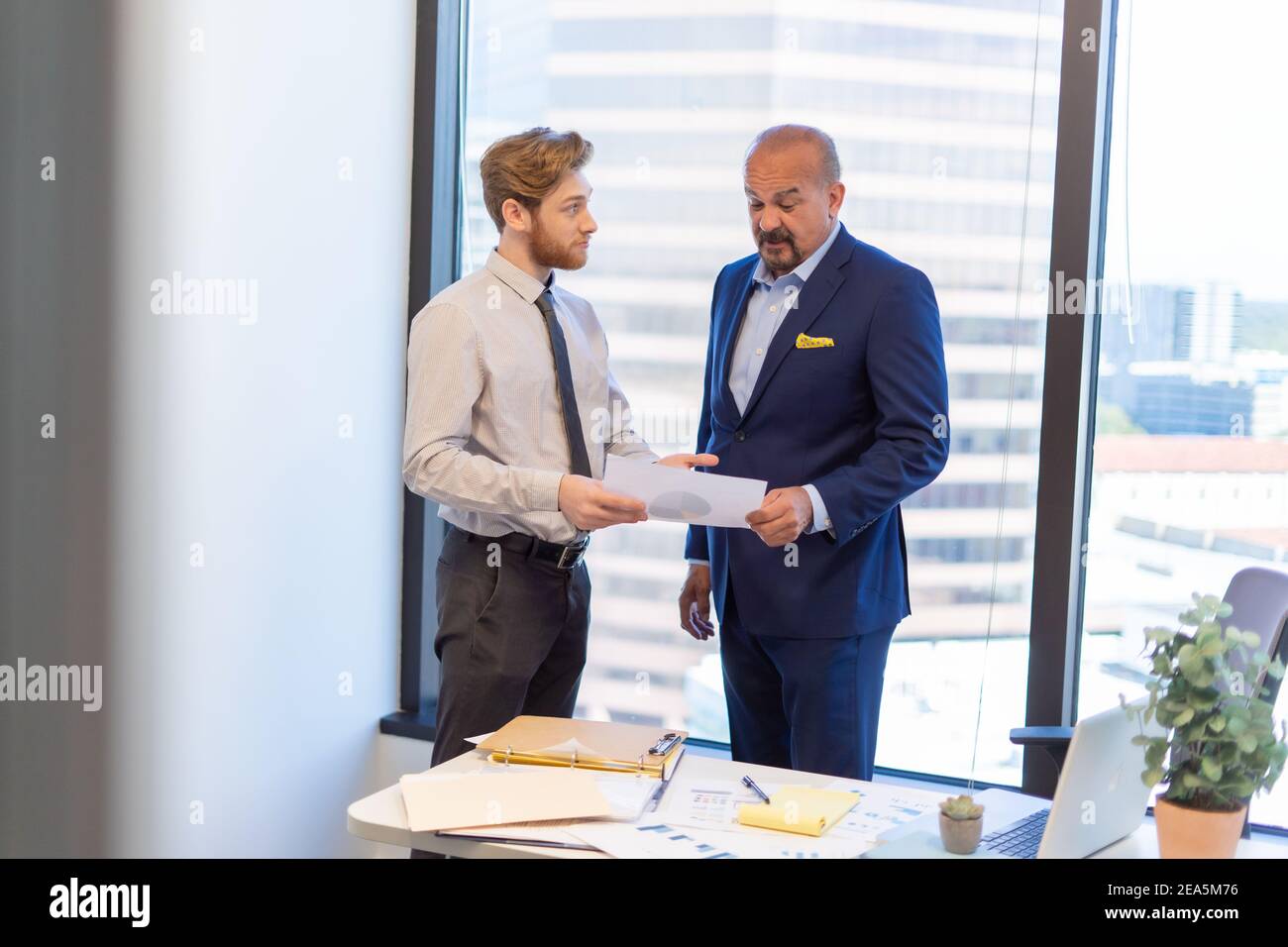 Office employee having a meeting with their team Stock Photo - Alamy