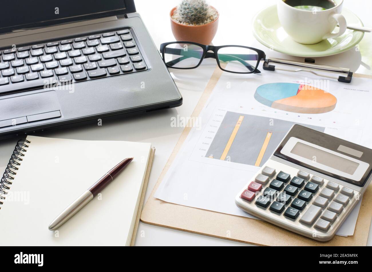 Accessories work laptop on the table, chart, calculator, pen Stock ...