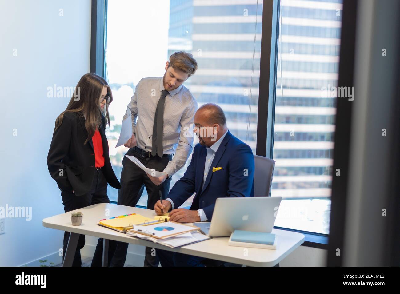 Office employee having a meeting with their team Stock Photo - Alamy