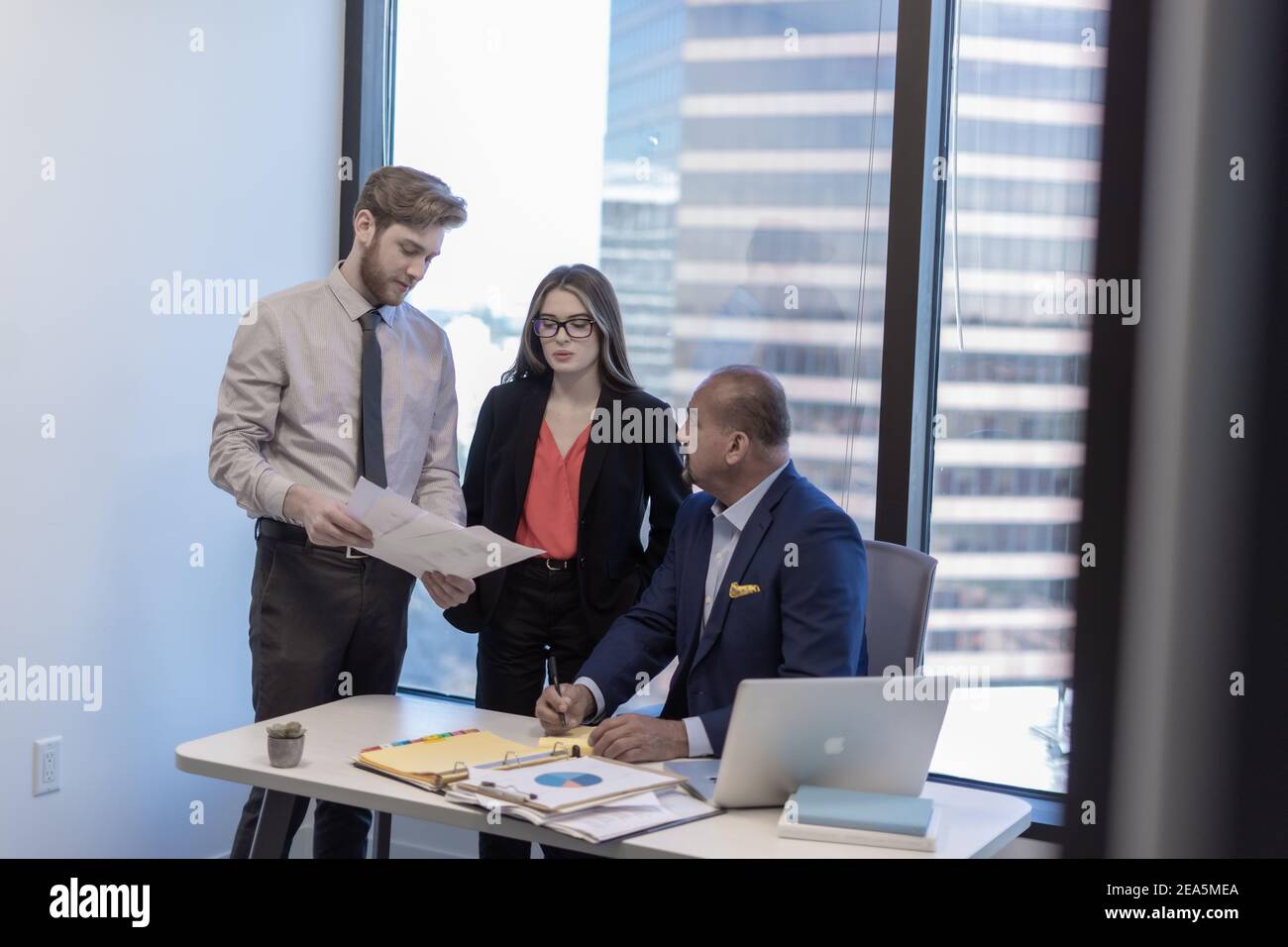 Office employee having a meeting with their team Stock Photo - Alamy