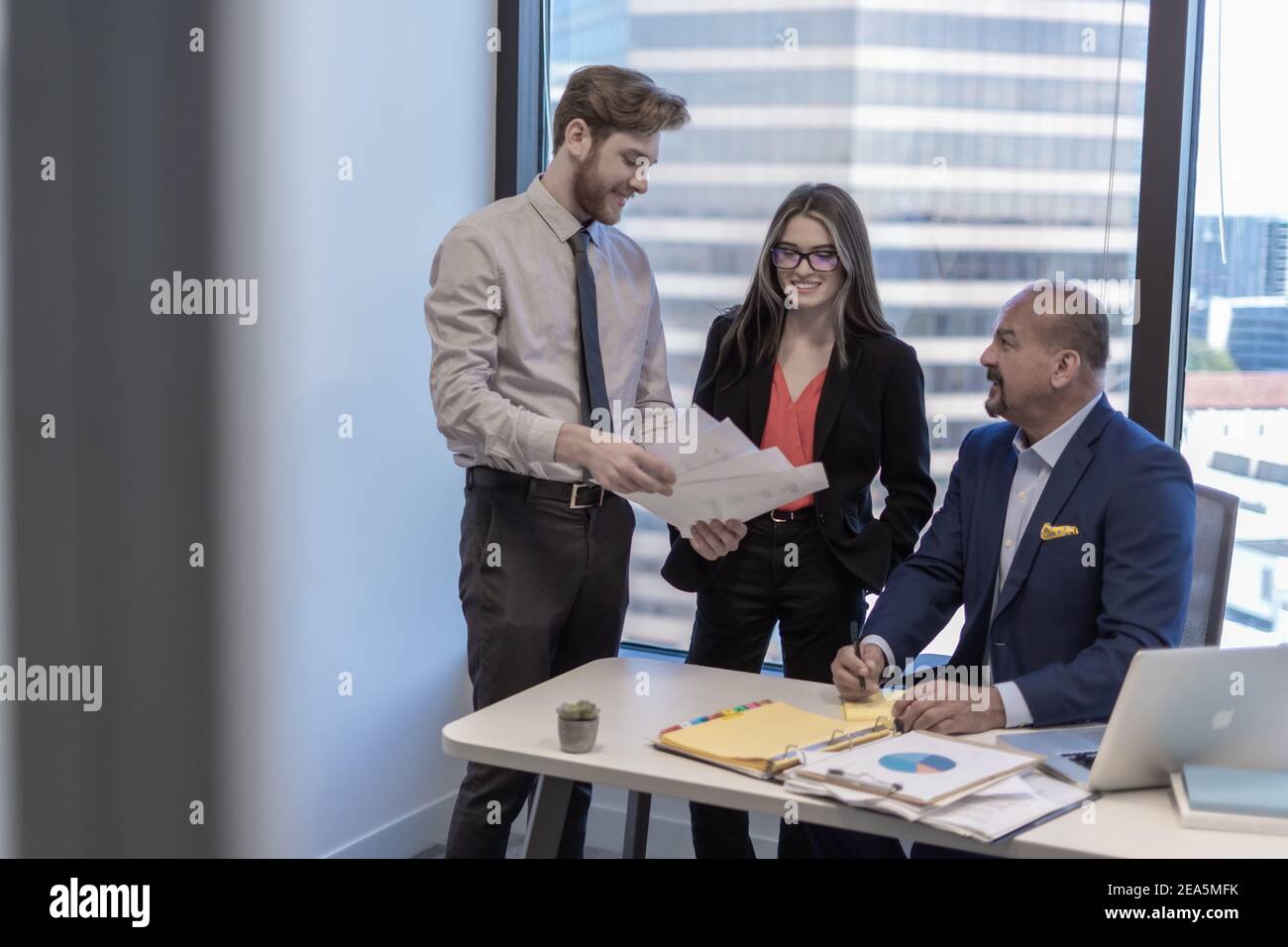Office employee having a meeting with their team Stock Photo - Alamy