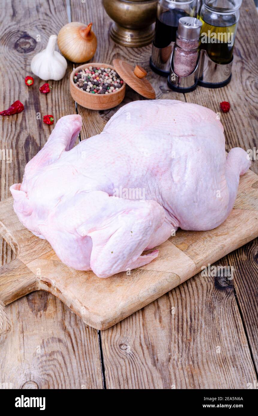 Raw chicken carcass on kitchen cutting board Stock Photo - Alamy