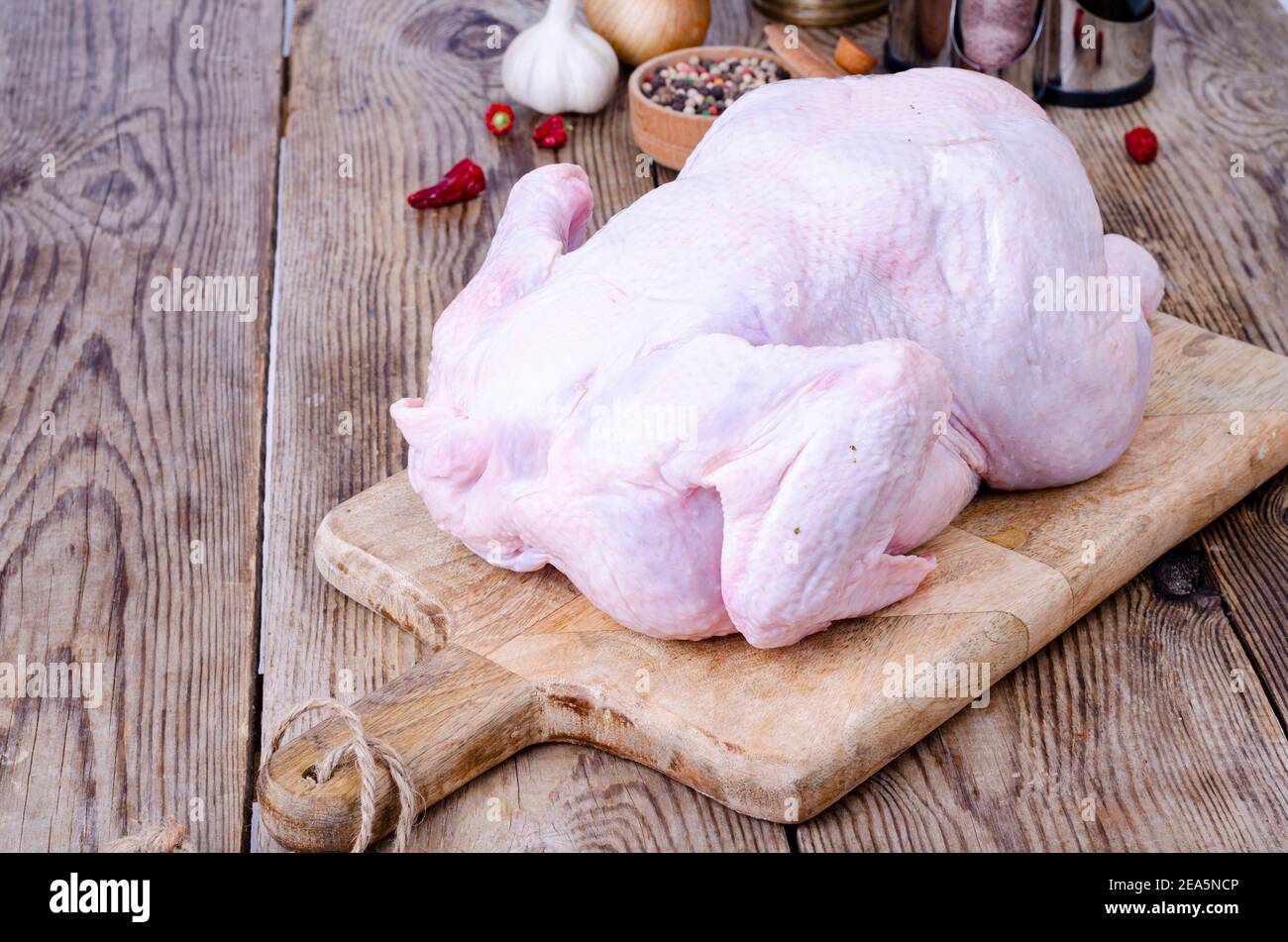 Raw chicken carcass on kitchen cutting board Stock Photo - Alamy