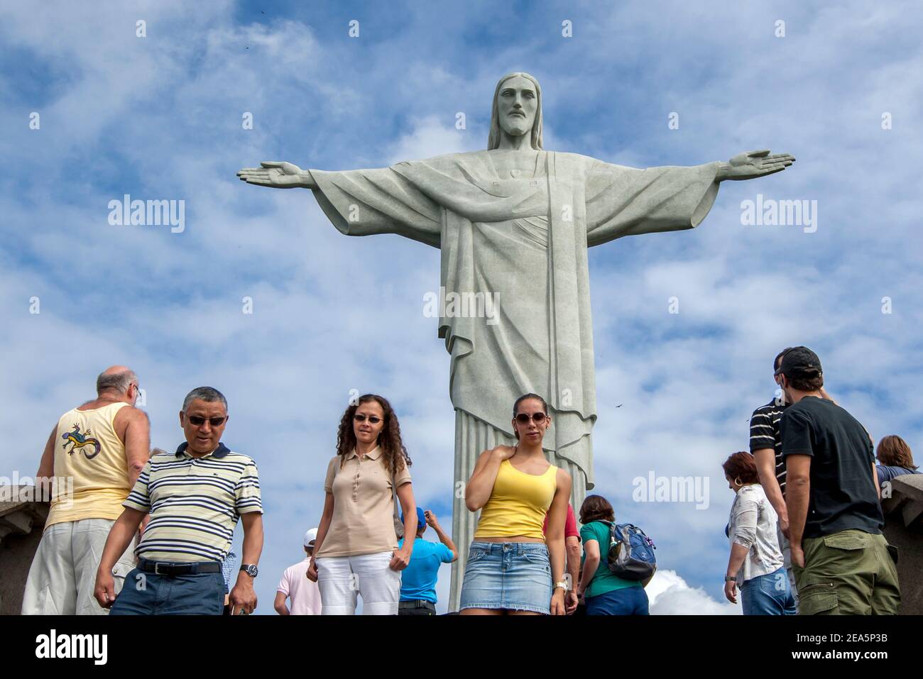 Tourists stand in front of the statue of Christ the Redeemer at Rio de ...