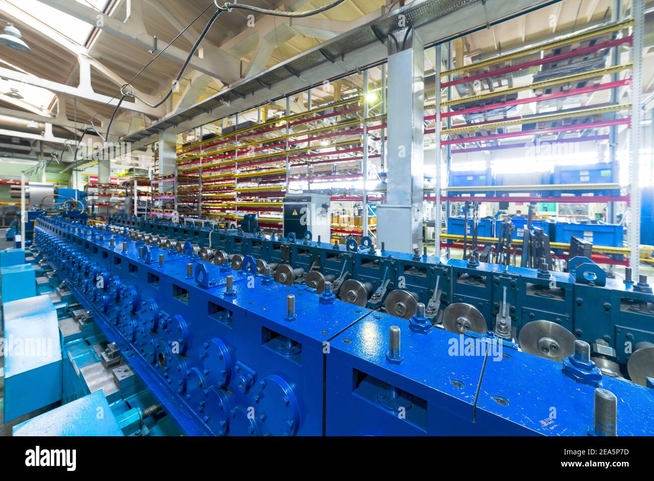 Roller forming machine. The interior of the plant producing a metal ...