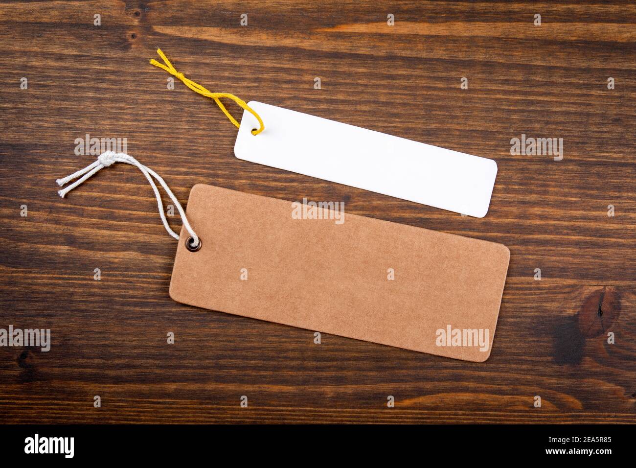 White paper and cardboard price tags on a wooden texture background ...