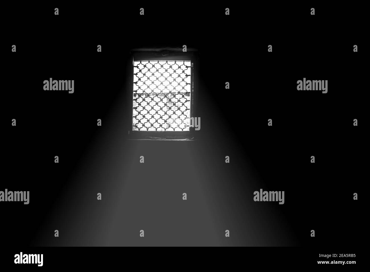 Cinematic dark mood shot of windows with some sunlight coming through ...