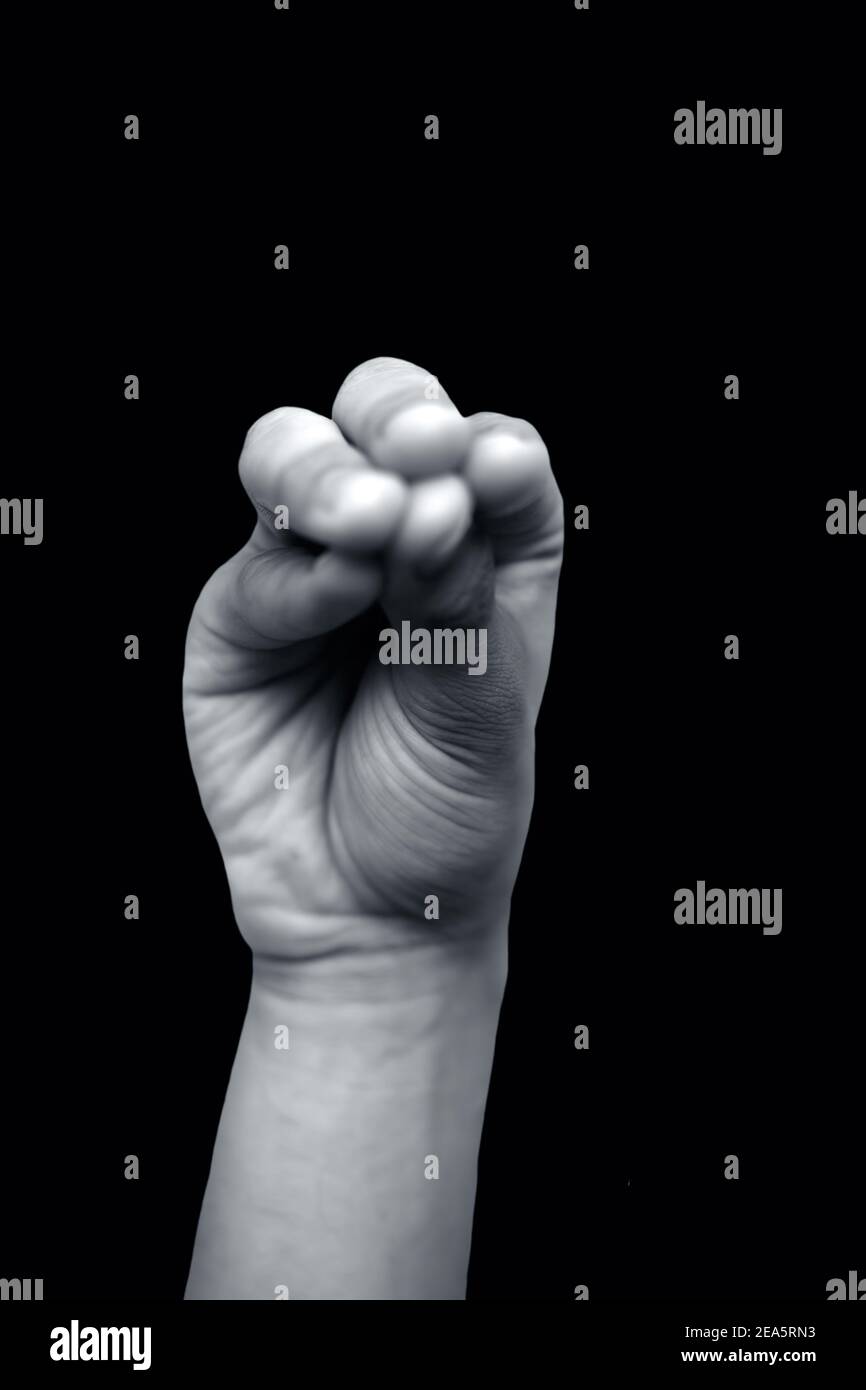Shot of male hands doing Mukula mudra isolated on black background ...