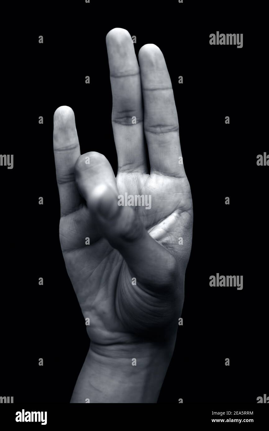 Shot of a hand doing Agni yoga or Surya Mudra or Gesture Of The Fire ...