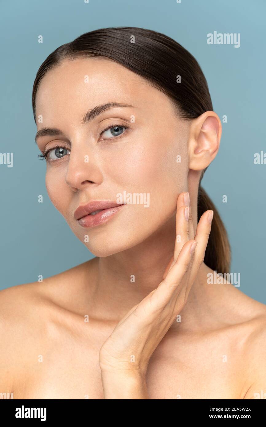 Young Woman With Natural Makeup Combed Hair Touching Well Groomed