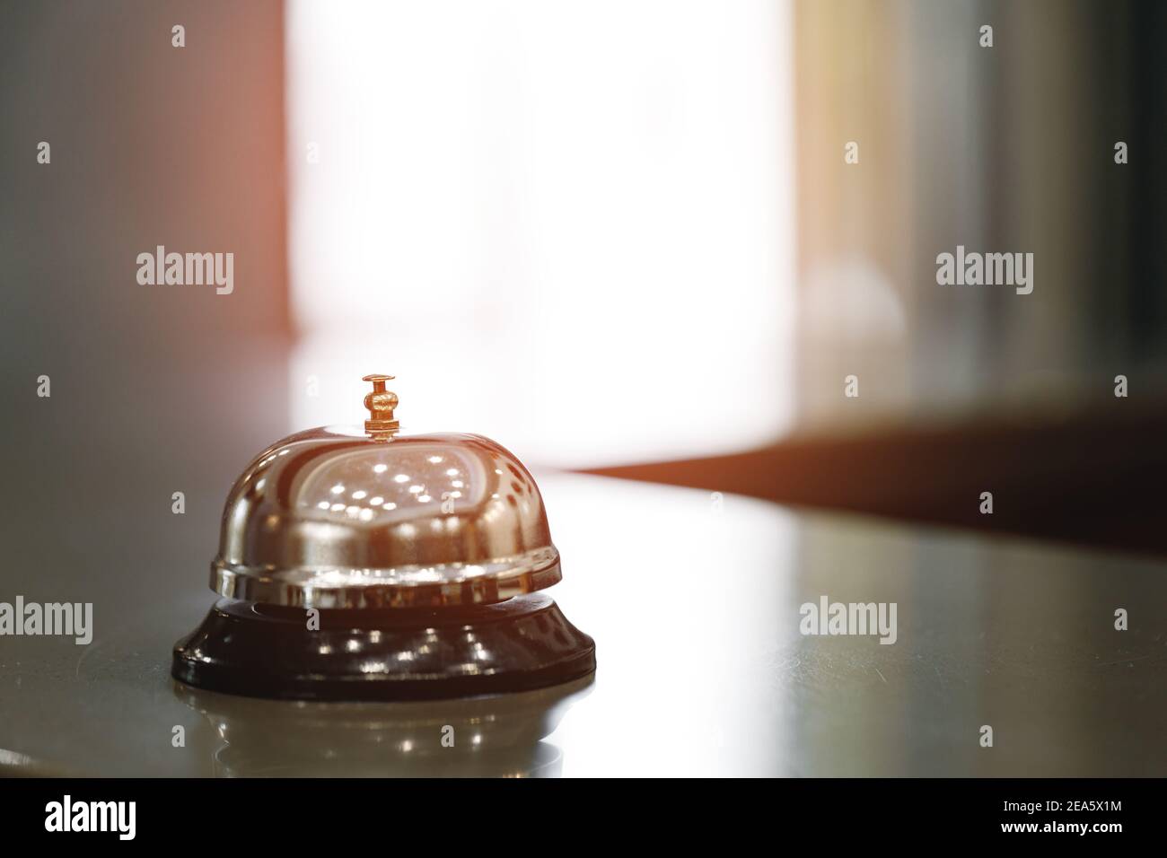 Hotel service bell on front desk counter Stock Photo - Alamy