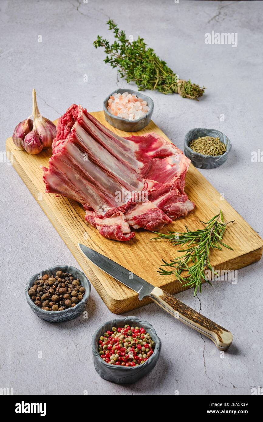Raw fresh deer ribs with spice and herb over concrete background Stock ...