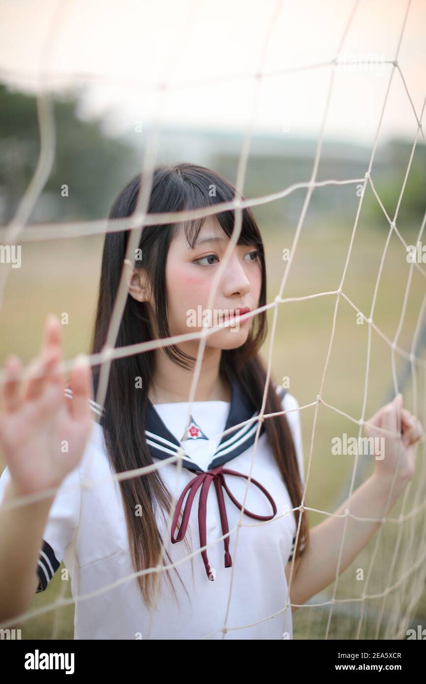 Portrait of beautiful Asian japanese high school girl uniform looking with net Stock Photo - Alamy