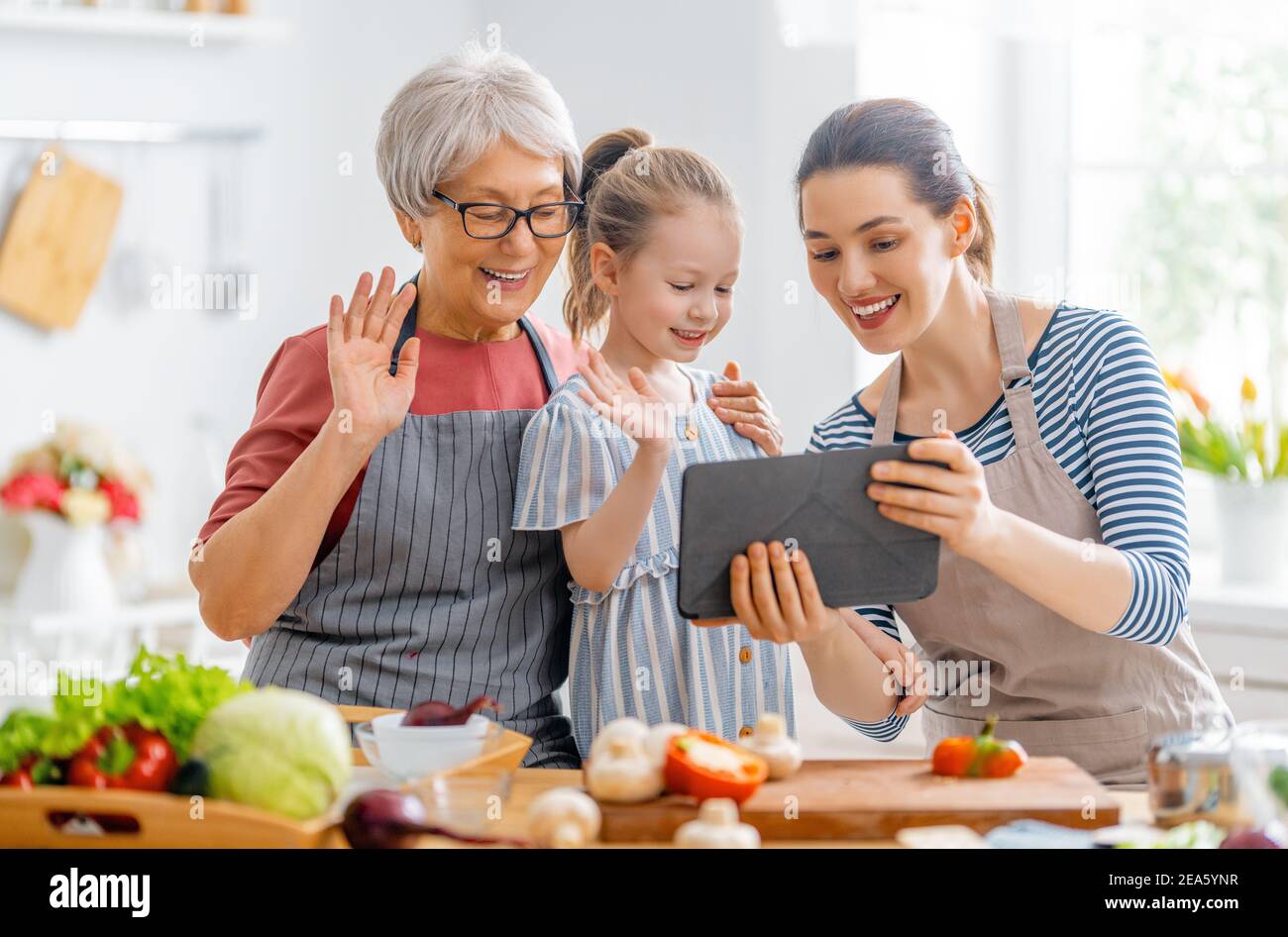 Healthy food at home. Happy family in the kitchen. Grandma, mother and ...