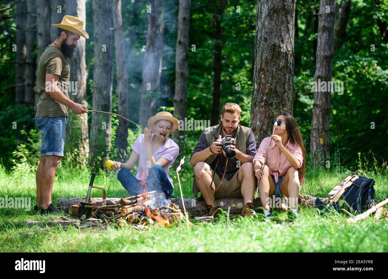Halt for snack during hiking. Company friends relaxing and having snack ...