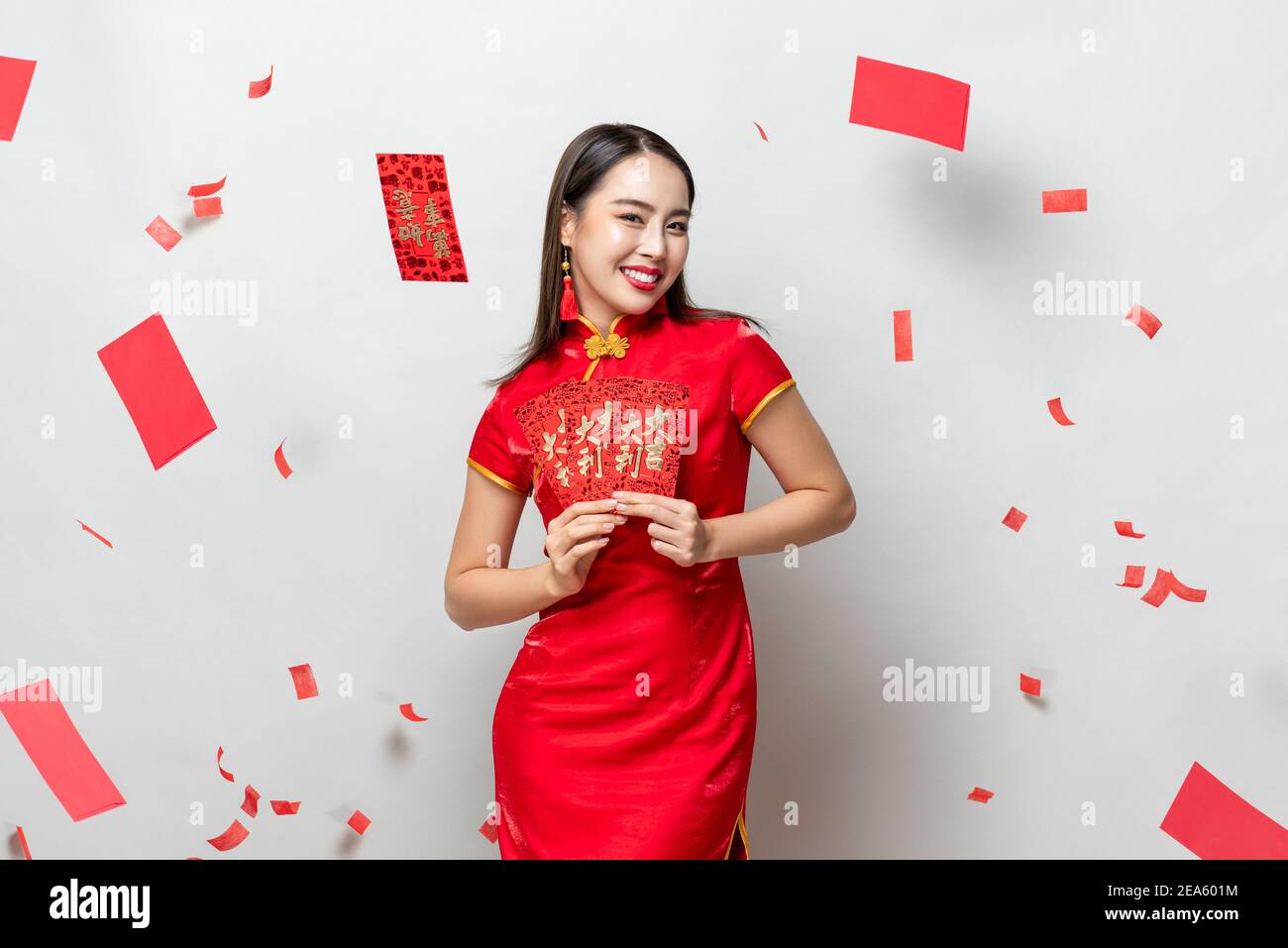 Smiling happy Asian woman in traditional oriental costume holding red ...