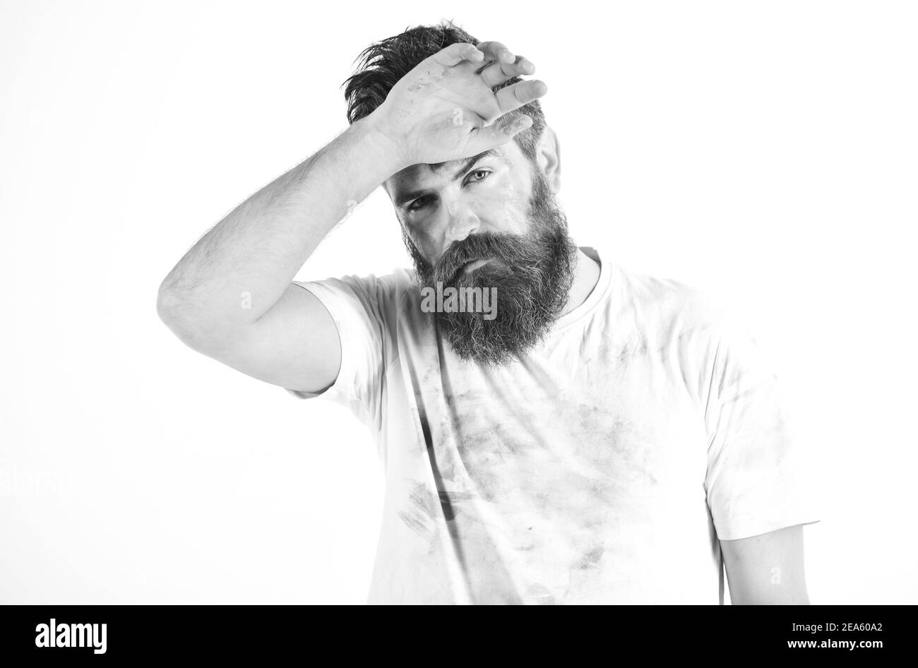 Man with beard in dirty dusty shirt looks exhausted. Builder, plasterer ...