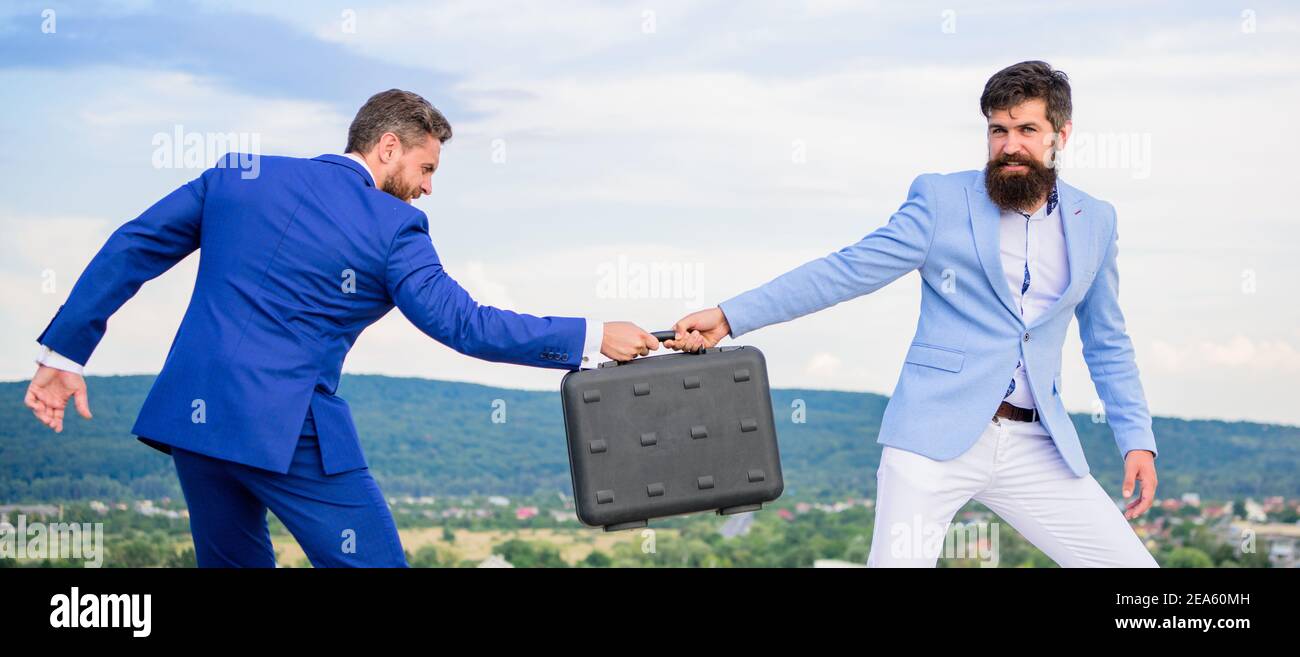 Businessman takes away briefcase from business partner. Fraud and ...