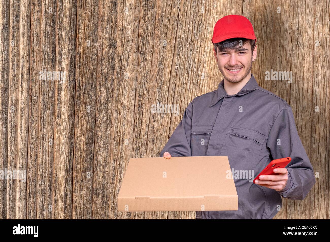 Fast food delivery man with pizza boxes in his hands delivering the ...