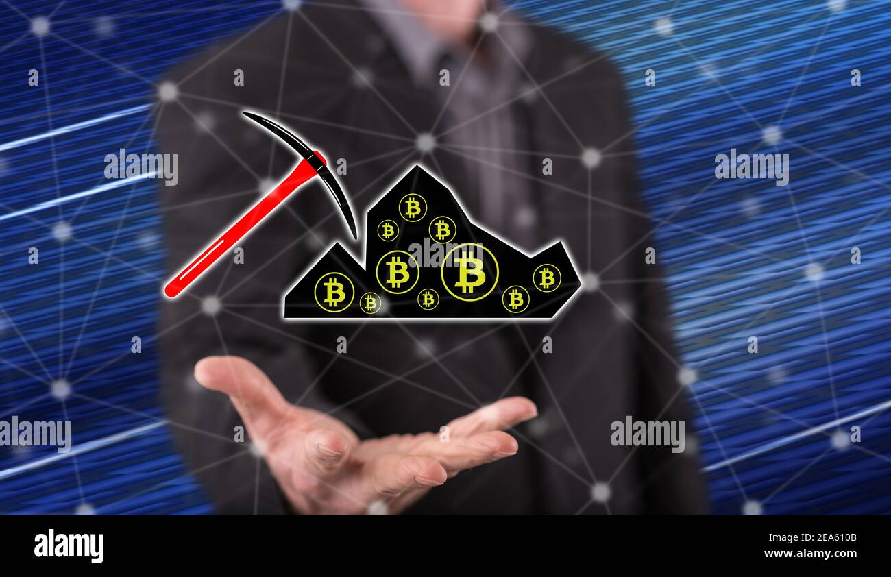 Bitcoin mining concept above the hand of a man in background Stock ...