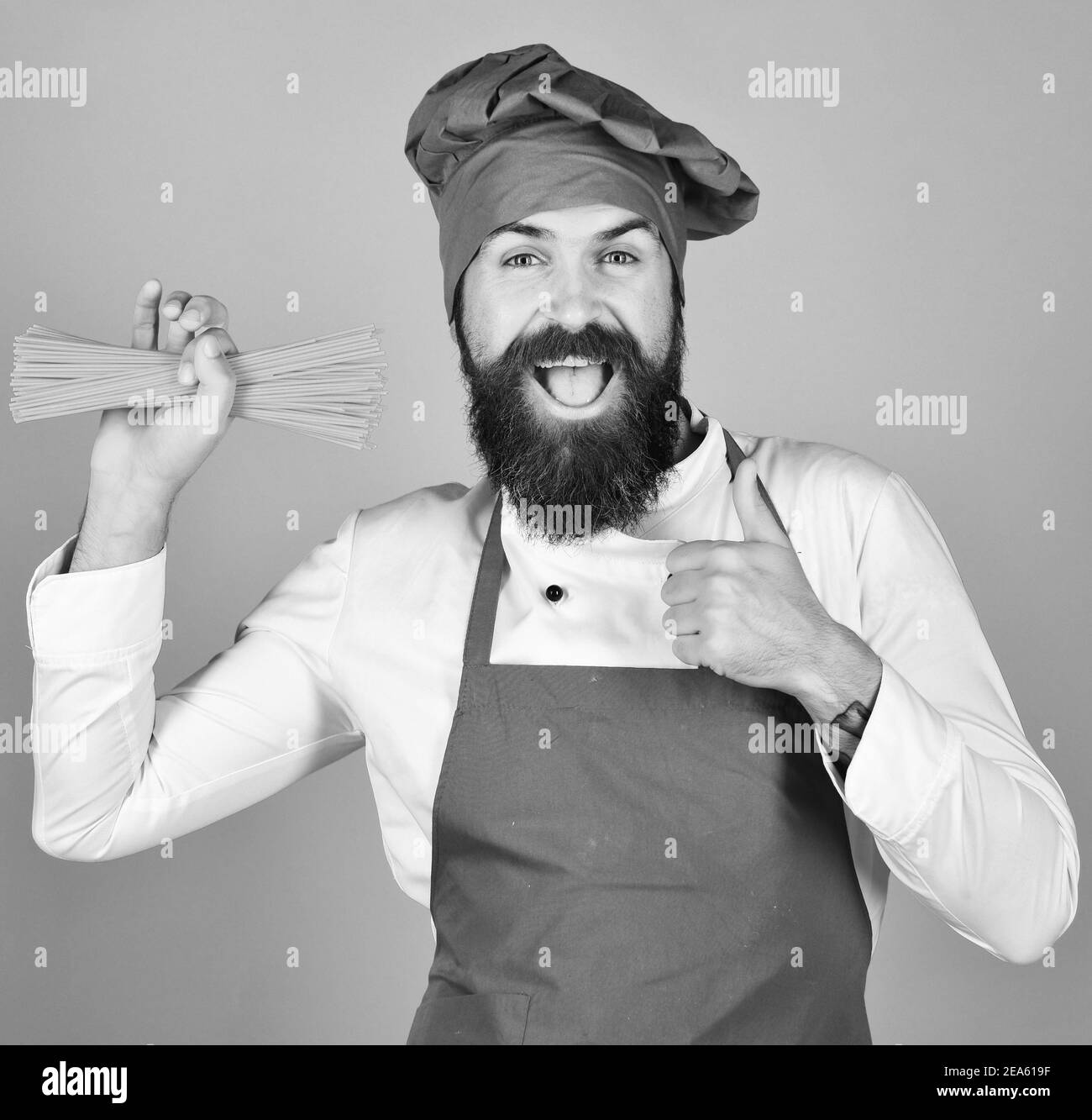 Italian restaurant concept. Man or hipster with beard holds macaroni on ...