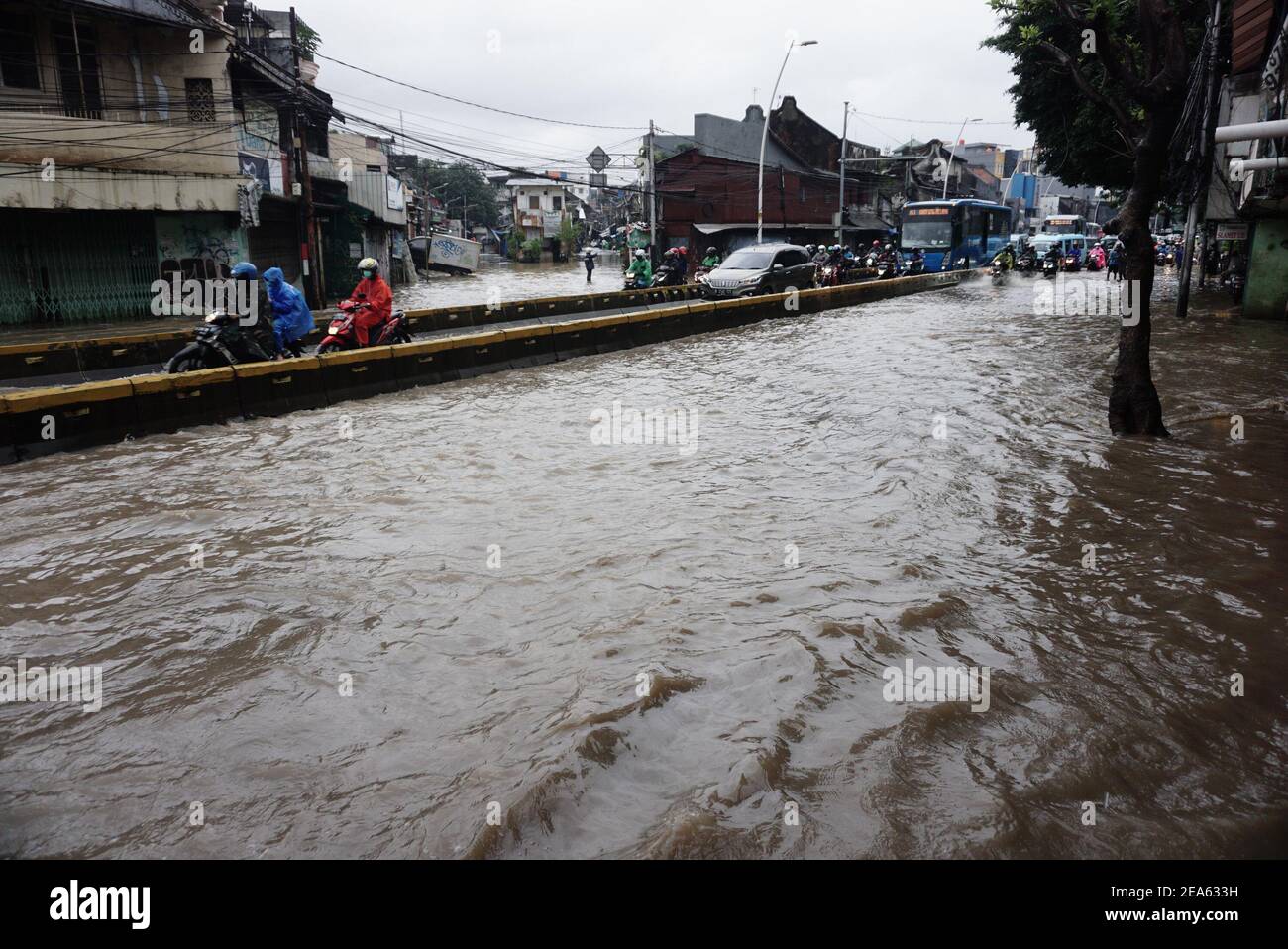 Jakarta, Indonesia. 8th Feb, 2021. Vehicles run though flood water ...