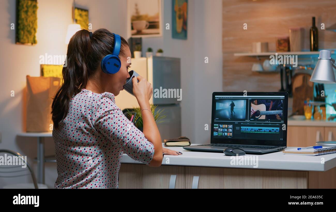 Woman video editor with headset working with footage and sound sitting ...