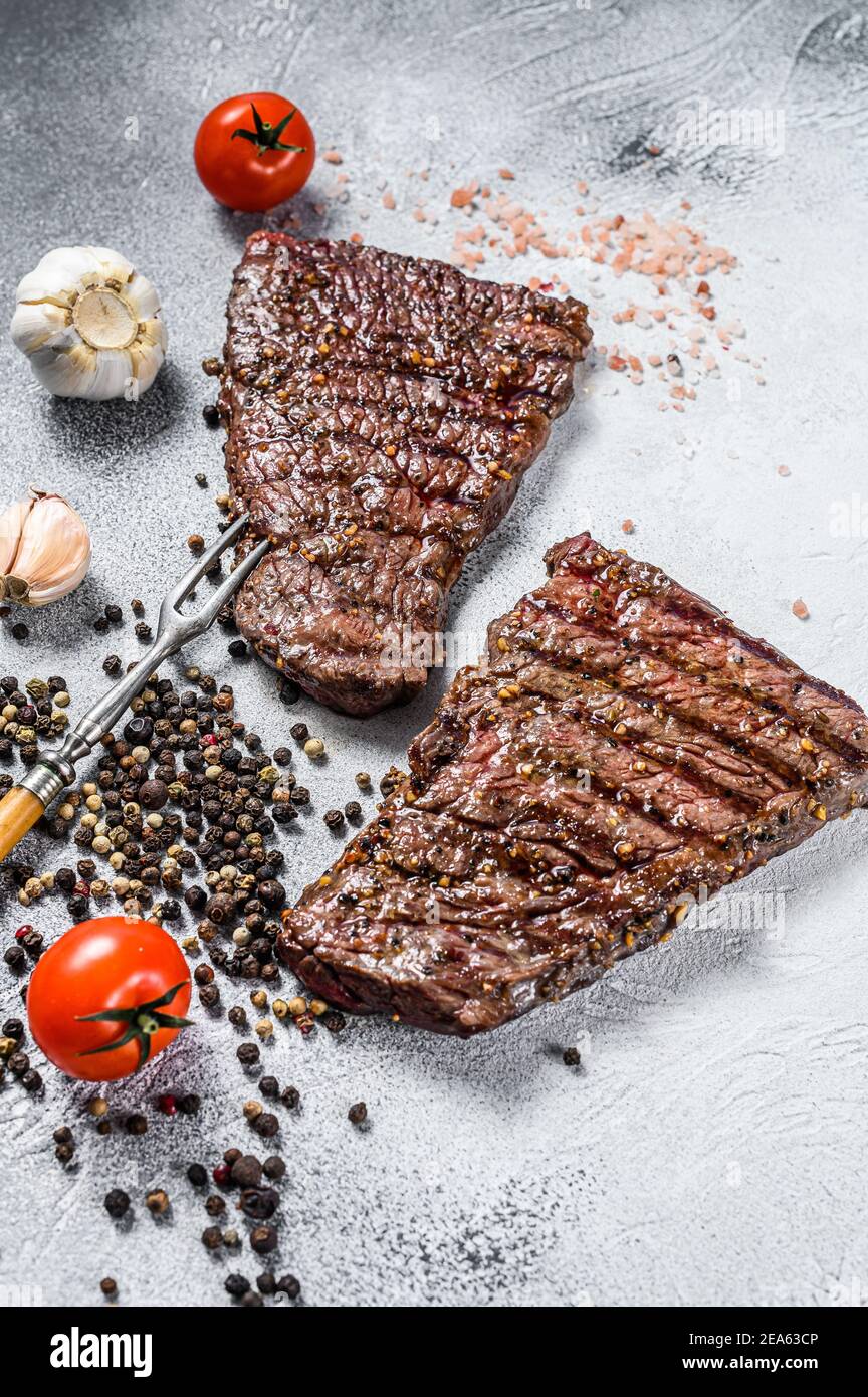Grilled rump steak with spices. BBQ beef. Gray background. Top view ...