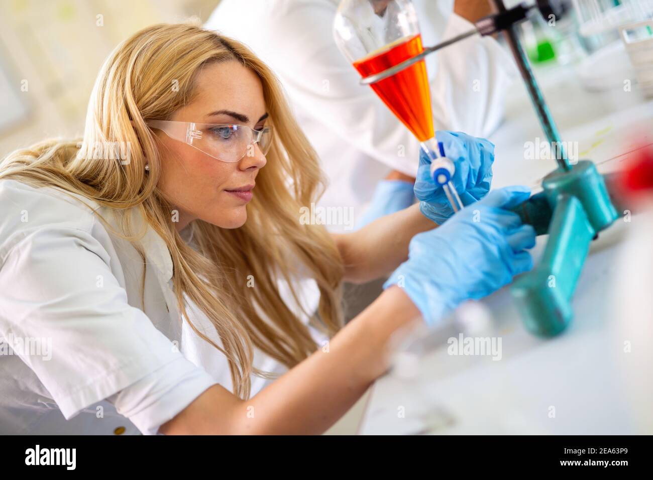 Attractive young woman scientist working in laboratory Stock Photo - Alamy