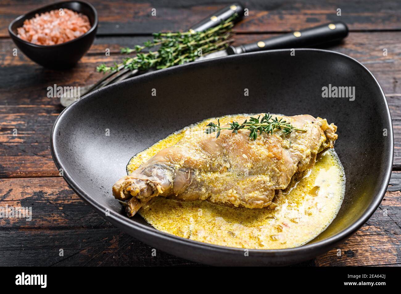 Stew with hare legs with rosemary and garlic. Wooden background. Top ...