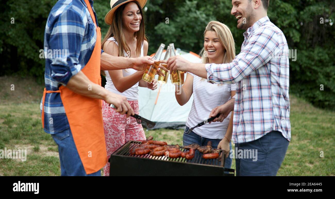 Friends making barbecue and having lunch in the nature Stock Photo - Alamy