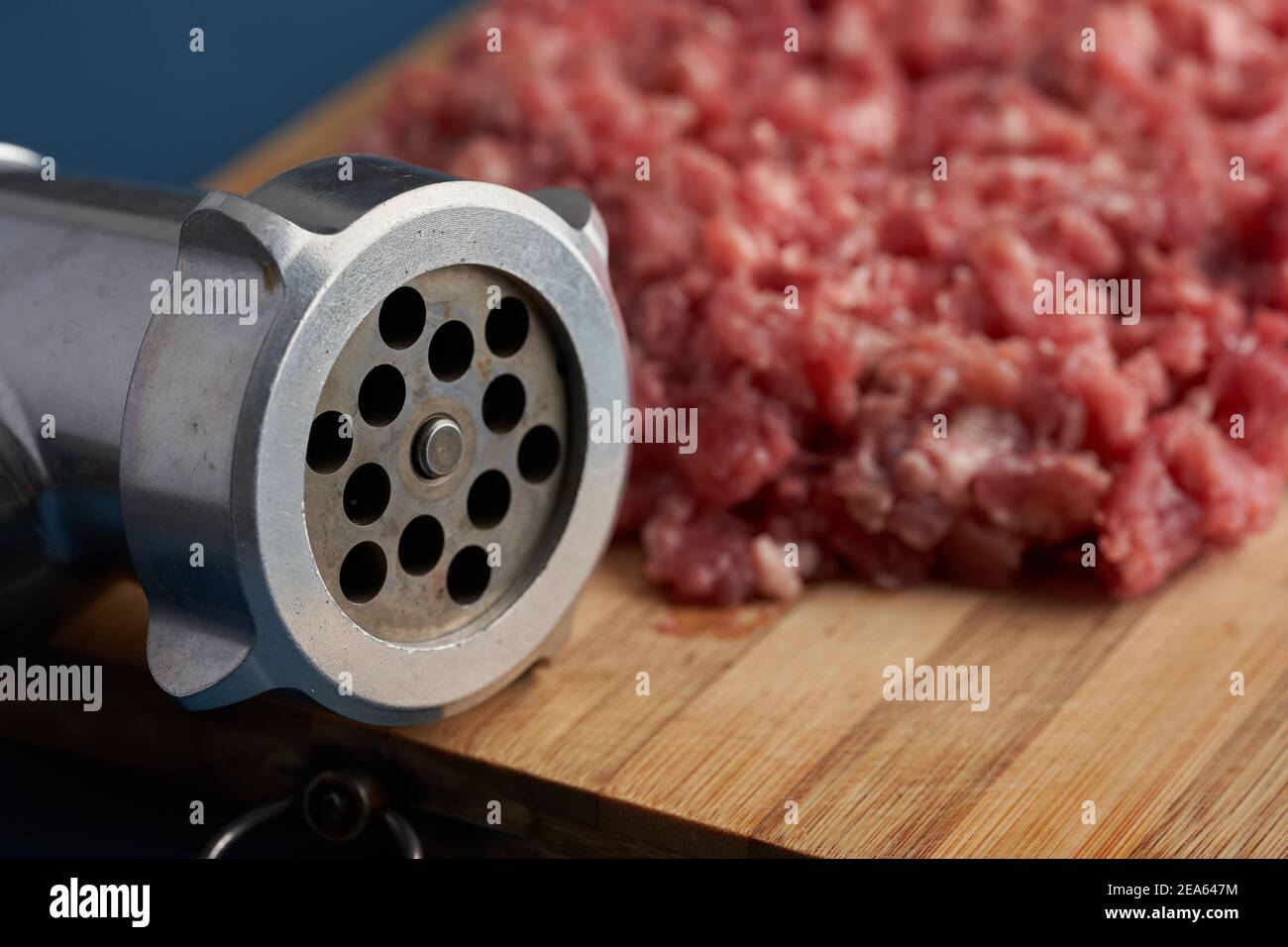 Meat grinder parts and minced meat on a wooden board Stock Photo - Alamy