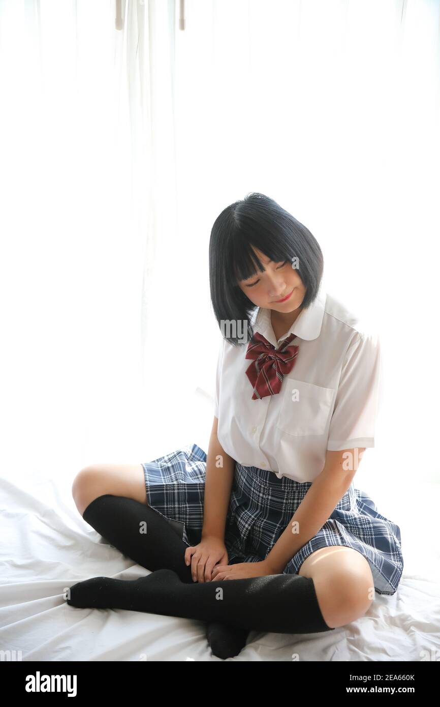 Portrait japanese school girl in white tone bed room Stock Photo - Alamy