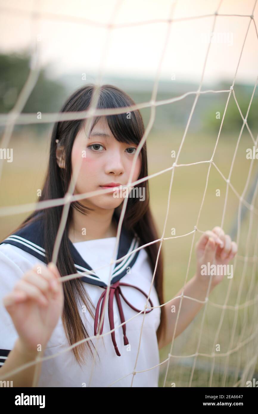 Portrait of beautiful Asian japanese high school girl uniform looking with net Stock Photo - Alamy